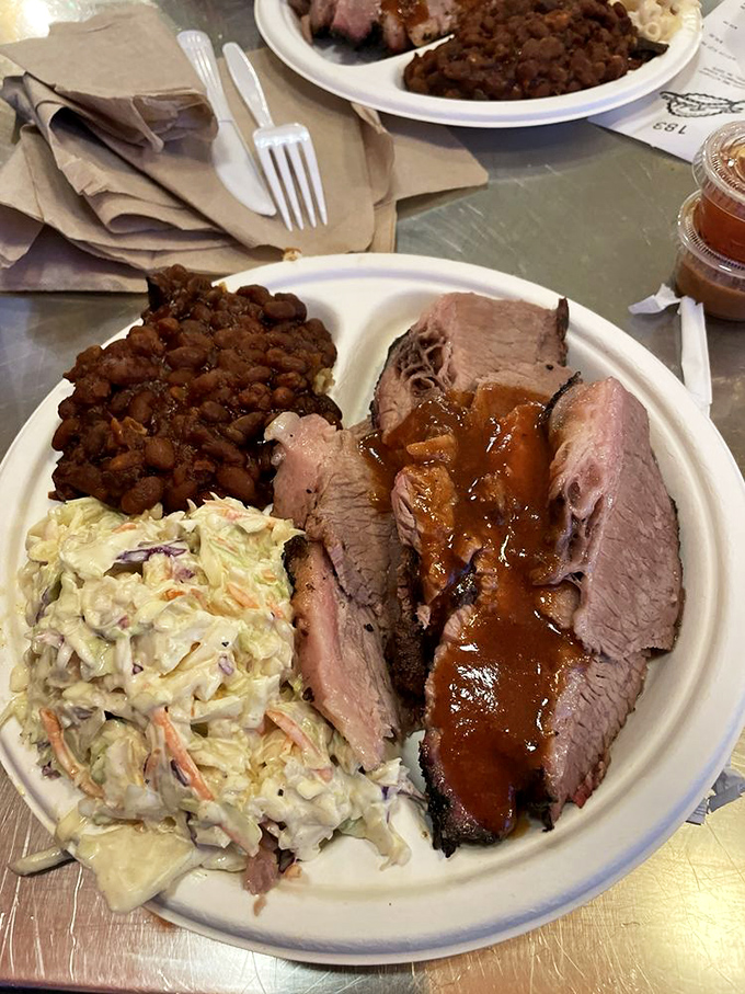 Brisket so tender, it practically slices itself. Paired with classic sides, it's a plate that would make any pitmaster proud.