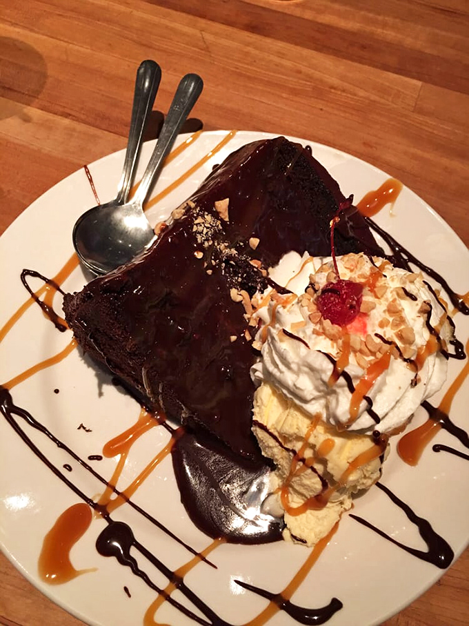 This chocolate brownie isn't just dessert—it's performance art. The whipped cream, caramel drizzle, and chocolate sauce are putting on a show worthy of Broadway.