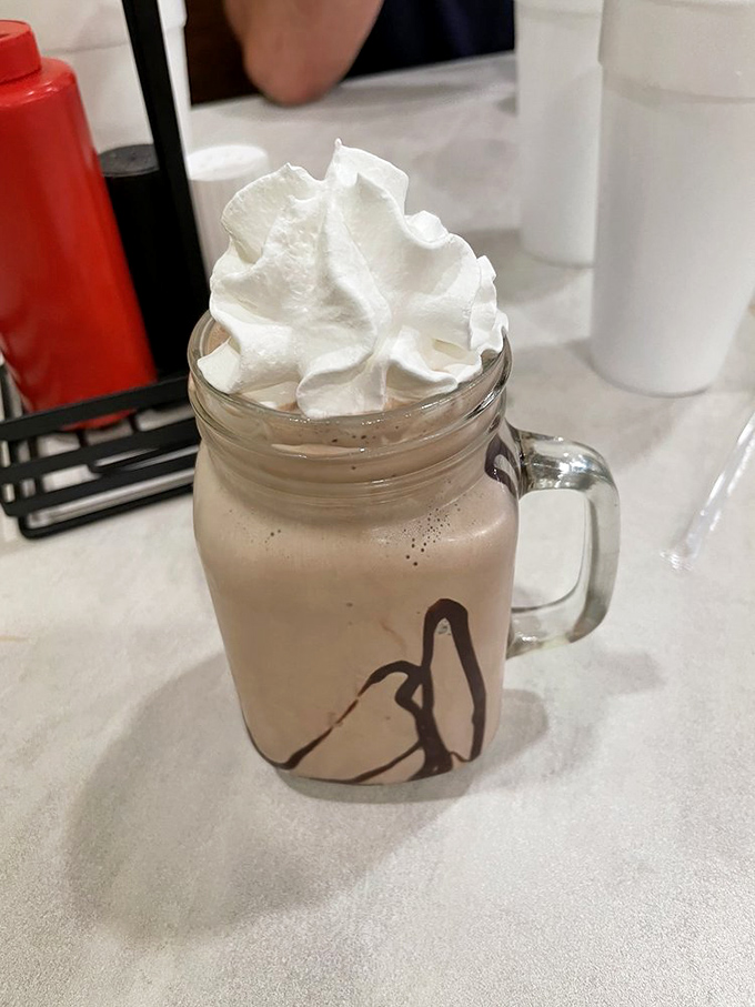 A chocolate shake served in a mason jar with whipped cream that defies gravity&mdash;proof that sometimes the best desserts don't need a passport.