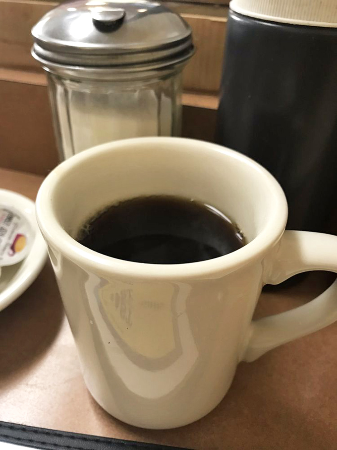 The elixir of life, served in a no-nonsense mug. This coffee promises to turn zombies into functioning humans, one sip at a time.