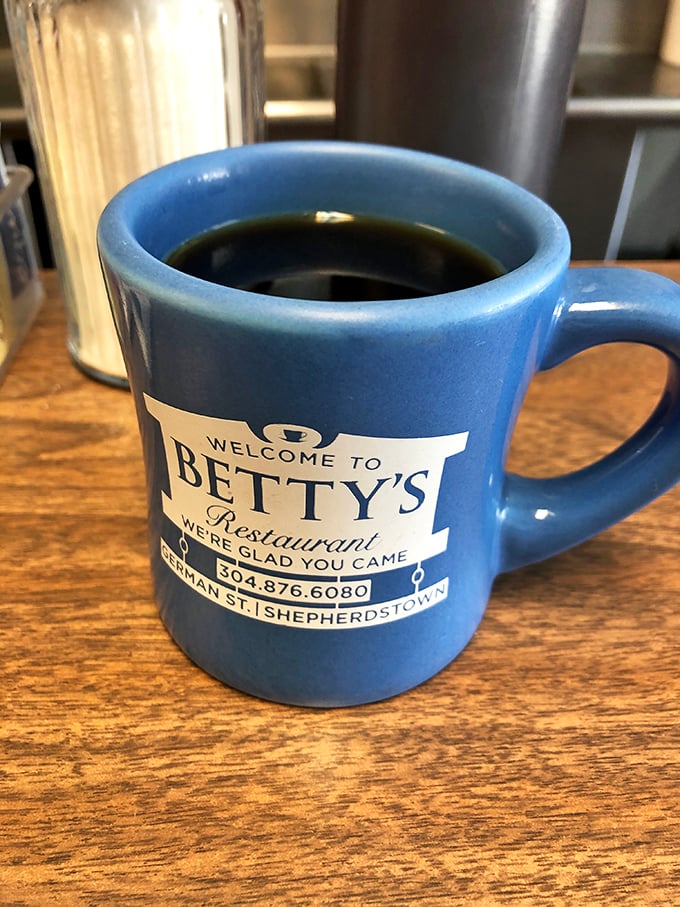 Betty's coffee mug: half vessel, half welcome wagon. It's not just serving joe; it's serving up a warm Shepherdstown hello.