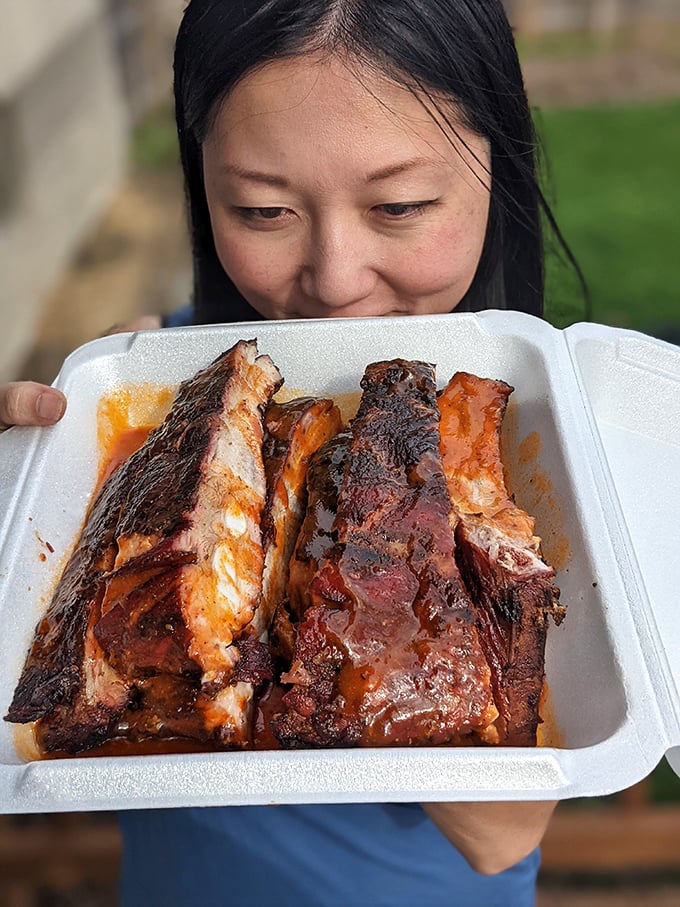A picture worth a thousand "yums"! This diner's face says it all – barbecue bliss is just a bite away.