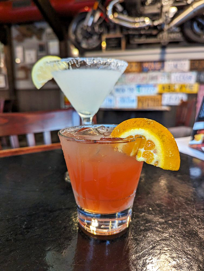 Cocktails at Anchor Bar &ndash; because something this spicy deserves something this refreshing. The lime and orange garnishes add a touch of class.