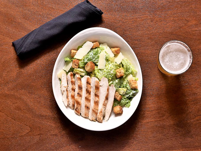 A Caesar salad that actually excites&mdash;grilled chicken fanned like it's posing for a magazine cover. Proof that healthy choices don't have to feel like punishment.