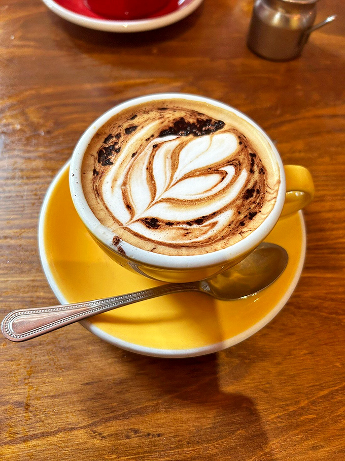 Coffee art or masterpiece? This latte is almost too pretty to drink – almost. The intricate leaf design is like a caffeinated Rorschach test.