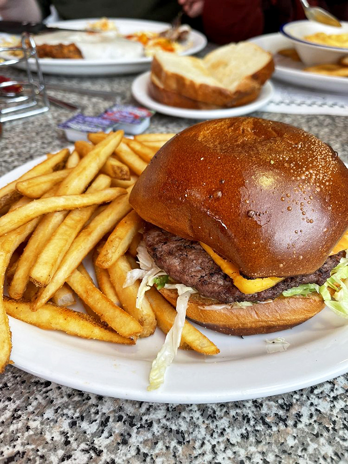 This cheeseburger's stacked higher than a game of Jenga. One bite, and you'll be singing "I'm All Shook Up" with your mouth full.