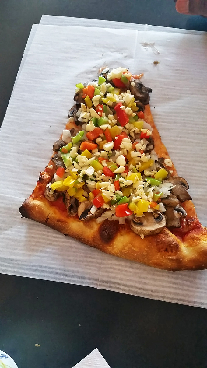 The slice that launched a thousand ships… or at least a thousand satisfied customers. Arinell's New York-style pizza is pure magic.