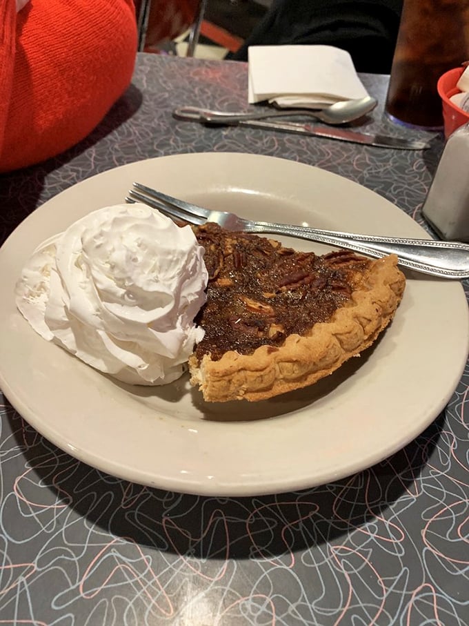 Holy pecan pie, Batman! This slice of heaven comes with a dollop of whipped cream so generous, it deserves its own zip code.