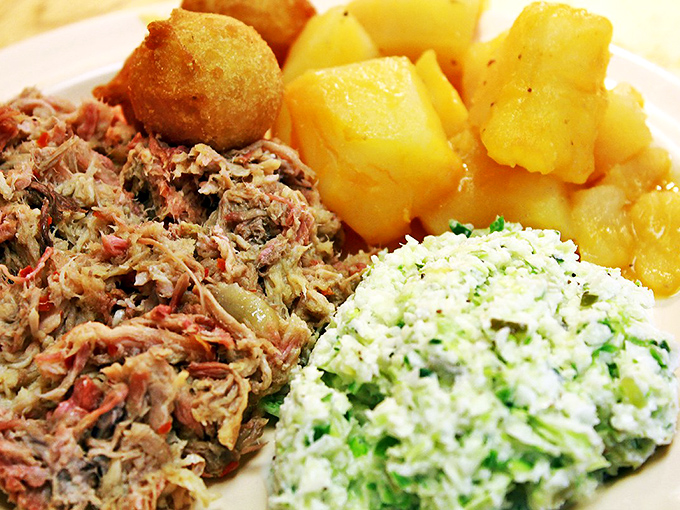 Pork BBQ that'll make you squeal with delight! This plate is a Southern symphony of flavors, with all the fixings playing backup.