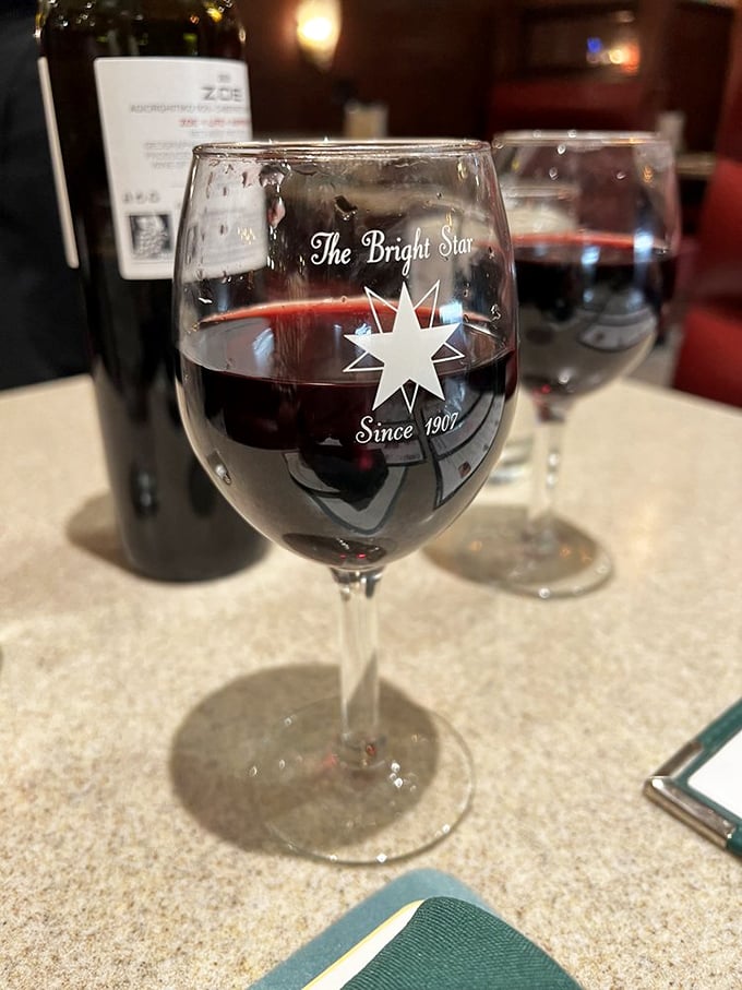 Raise a glass to good times! This ruby-red wine, served in the Bright Star's signature glass, is the perfect companion for your culinary journey.