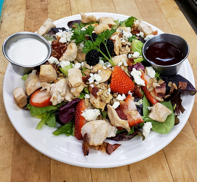A salad that's having an identity crisis &ndash; thinks it's a gourmet meal. With chicken, strawberries, and enough toppings to make a buffet blush.