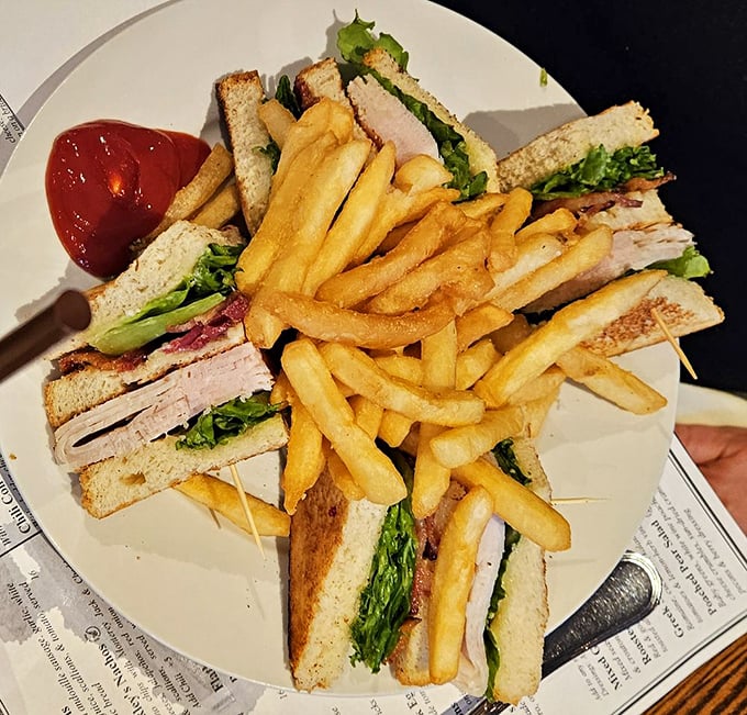 The club sandwich that puts all others to shame! Stacked higher than a Jenga tower, this triple-decker delight is a testament to the power of turkey and bacon.