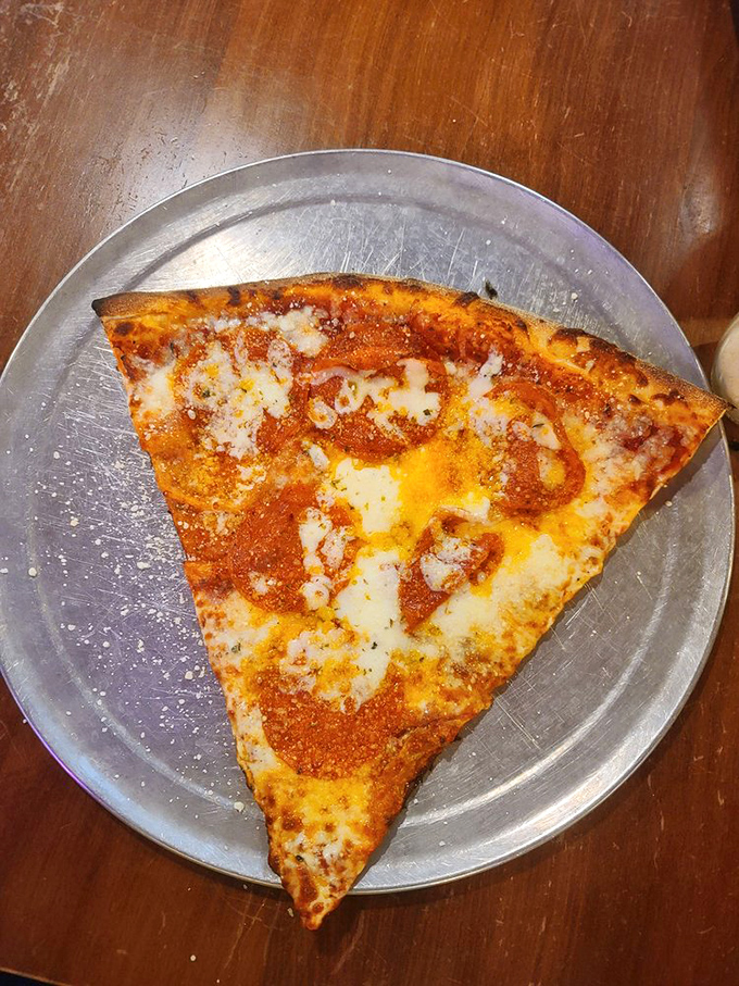 Cheese so gooey, it's doing the wave. This slice is bringing its A-game to your taste buds' party.