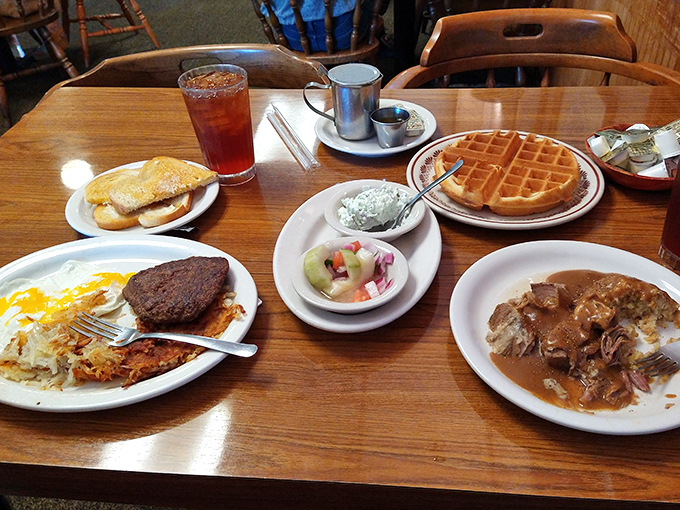 A breakfast spread that would make Ron Swanson proud: waffles, eggs, and enough sides to feed a small army.
