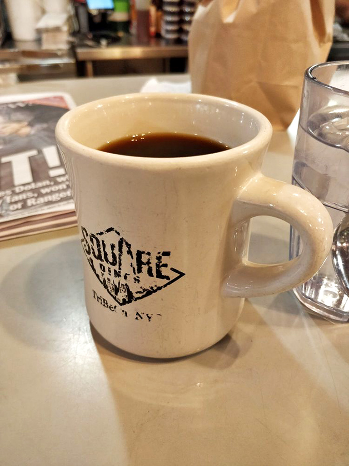Wake up and smell the nostalgia! Square Diner's coffee comes with a side of charm in this mug that's seen more stories than a librarian.