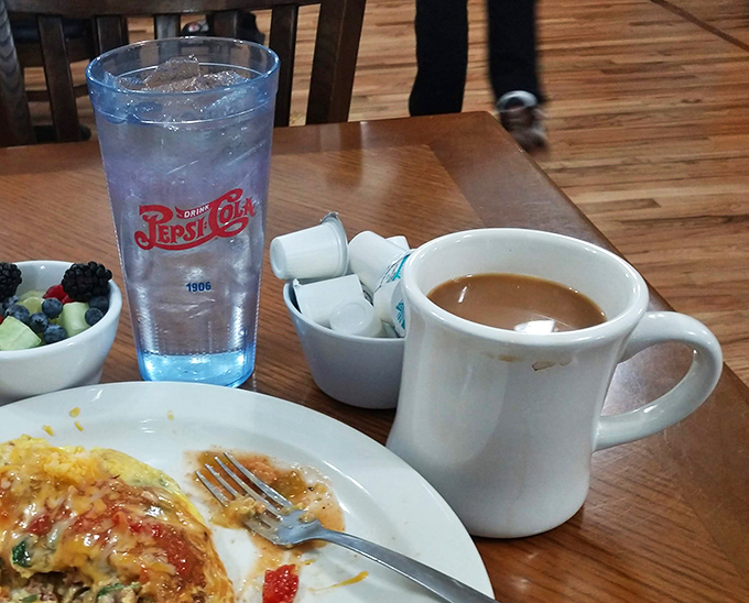 The holy trinity of breakfast: coffee, omelet, and fruit. A balanced meal for champions... and those pretending to be healthy.