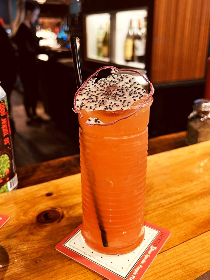 This isn't just a cocktail&mdash;it's an adult Dragon's Blood potion garnished with what appears to be a magical dragon fruit slice.