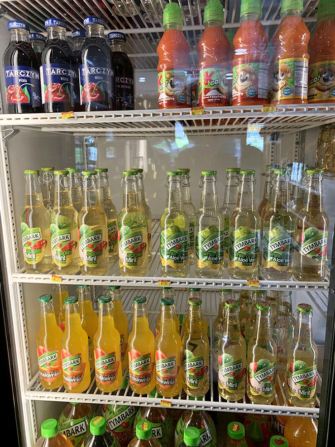 The refrigerator case is a United Nations of Polish beverages. Tymbark and Tarczyn bottles stand at attention, ready to wash down your pierogi parade.