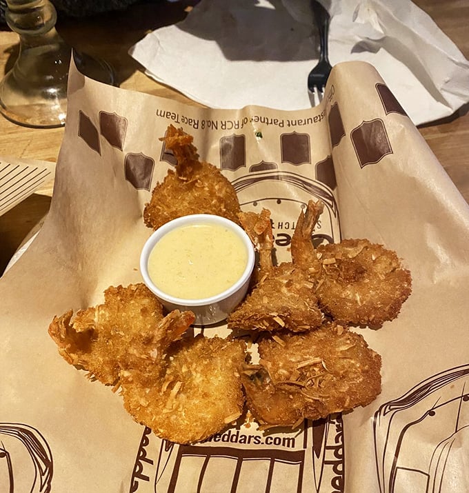Golden-fried shrimp with a crispy coconut coating that shatters with each bite. The dipping sauce is just a bonus at this point.