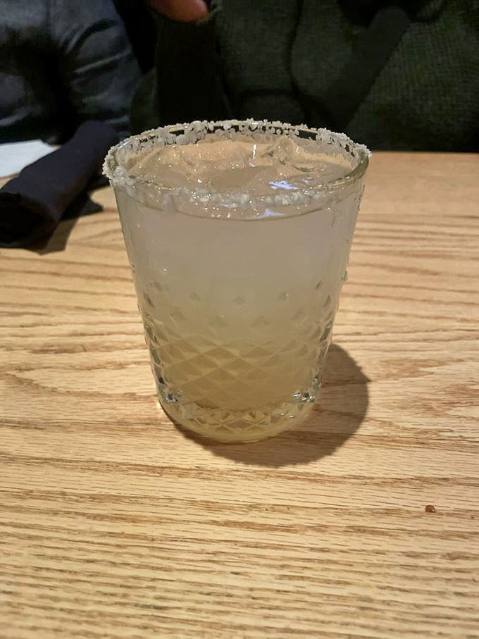 The margarita arrives in crystalline splendor, salt-rimmed and ready to complement the parade of savory delights heading to your table.