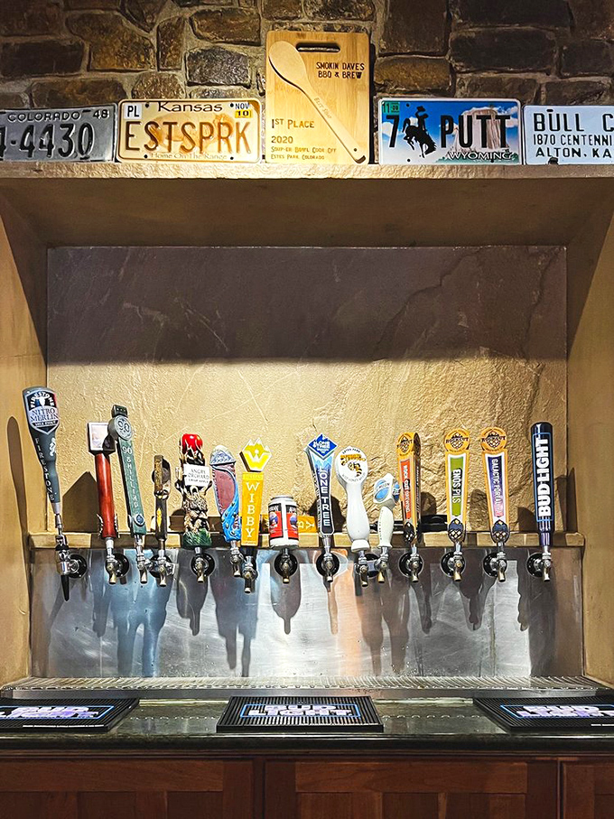 The beer tap lineup showcases Colorado's liquid gold alongside license plates from barbecue pilgrimage states. Hydration with hometown pride.