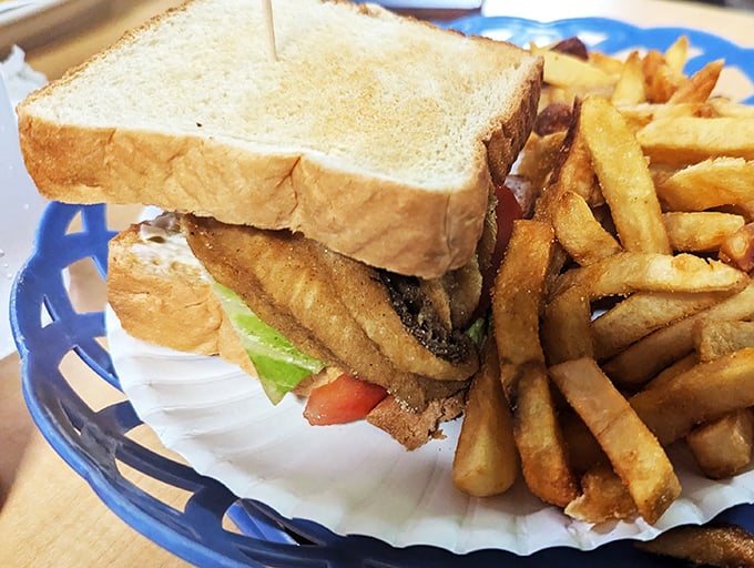 Behold, the sandwich that puts the "wich" in delicious! Golden fries on the side make this plate a dynamic duo of delectability.