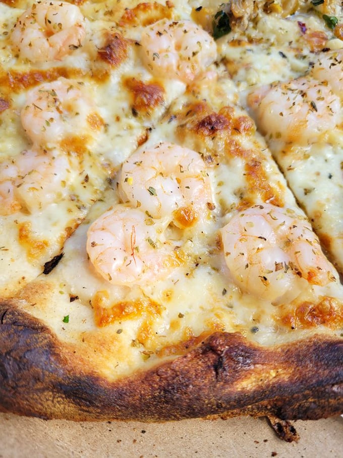 Surf's up on this pizza! Succulent shrimp dance atop a sea of melted cheese, bringing coastal flavors to the heart of Connecticut.