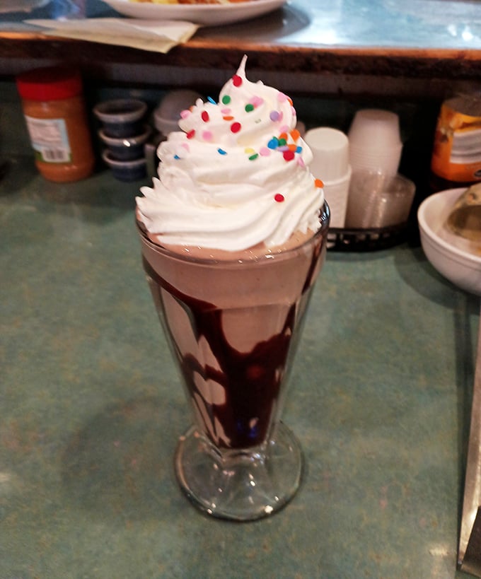 Milkshake madness! This towering treat isn't just a drink; it's a dessert, a work of art, and quite possibly the meaning of life all in one glass.