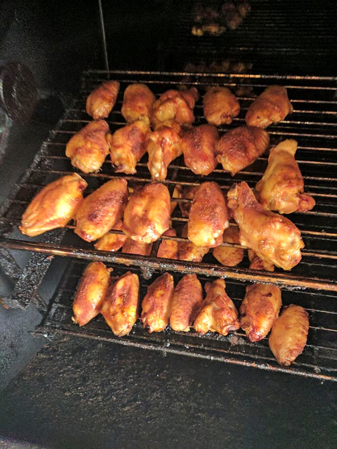 Chicken wings getting the smoke treatment&mdash;proof that barbecue isn't just a cooking method, it's a philosophy that improves everything it touches.