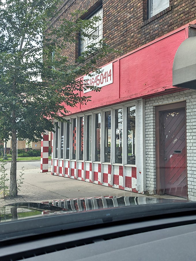 Checker Board Pizza's eye-catching exterior: Red and white squares bolder than a chess master's moves. Your taste buds are about to be checkmated!