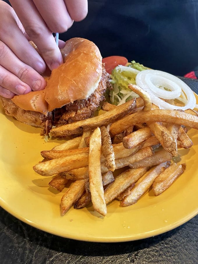 Hold onto your napkins, folks! This chicken sandwich is stacked higher than a Jenga tower and twice as satisfying when it all comes tumbling down.