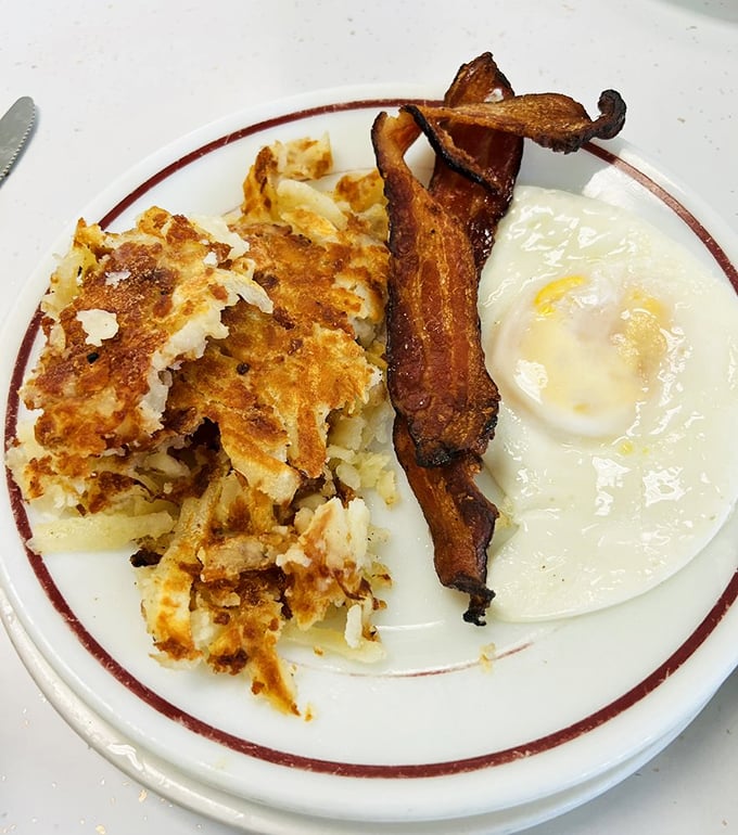 Crispy hash browns, sunny-side-up eggs, and bacon that could make a vegetarian weep. It's the breakfast trifecta of champions!