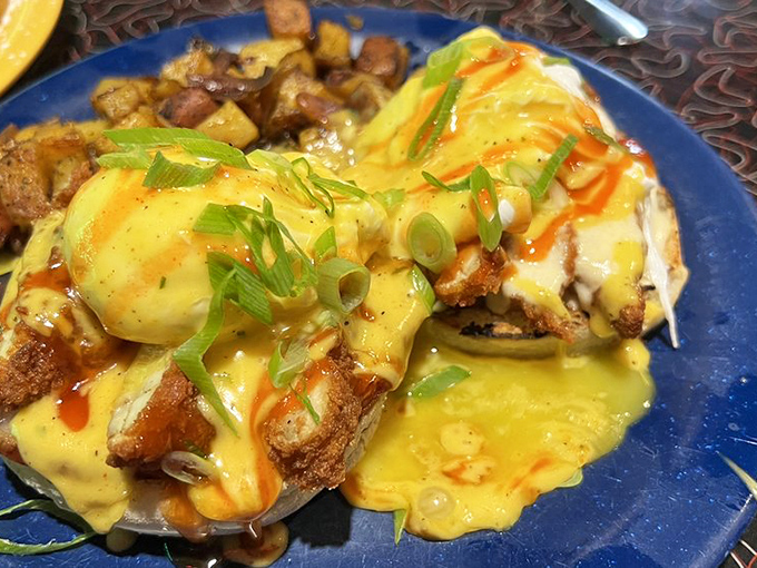 Holy Hollandaise! This Eggs Benedict is stacked higher than a Jenga tower, but way more satisfying when it falls.