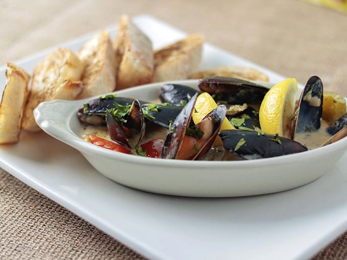 Mussels in their own little hot tub! These plump beauties are having a flavor party, and you're invited to dive in.
