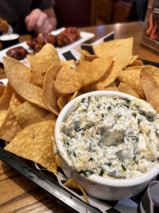 The spinach artichoke dip surrounded by a fortress of tortilla chips stands ready for the inevitable "I'll just have one more" battle.