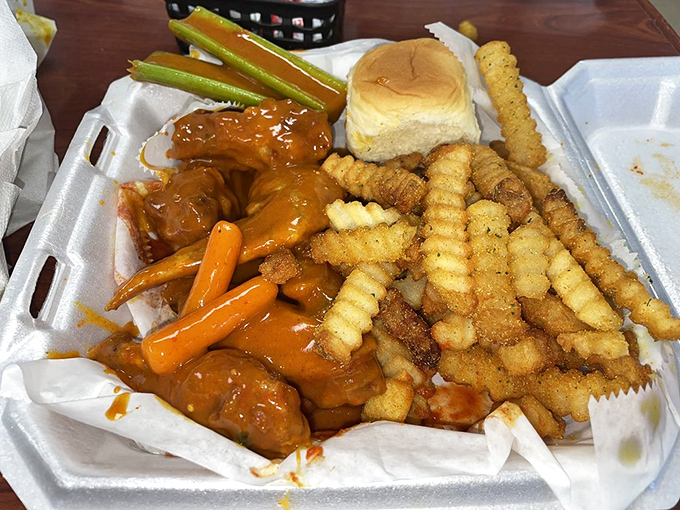 The holy trinity of comfort food: perfectly fried wings, seasoned fries, and a soft roll. Simplicity at its most delicious.