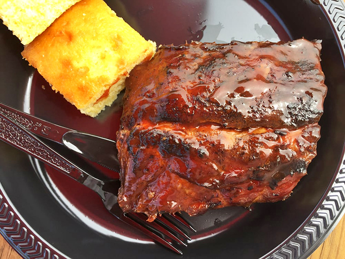 Ribs glazed to perfection, glistening like they've been polished by barbecue angels. That cornbread is the supporting actor who steals the show.