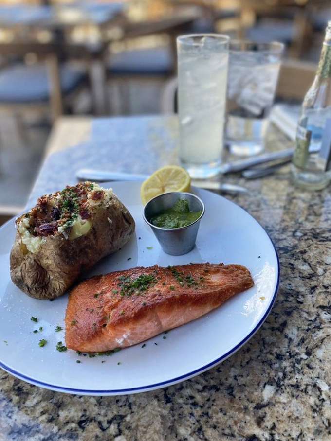 Salmon says "aloha"! This perfectly cooked fillet, nestled beside a baked potato, is ready to take your taste buds on a Pacific adventure.
