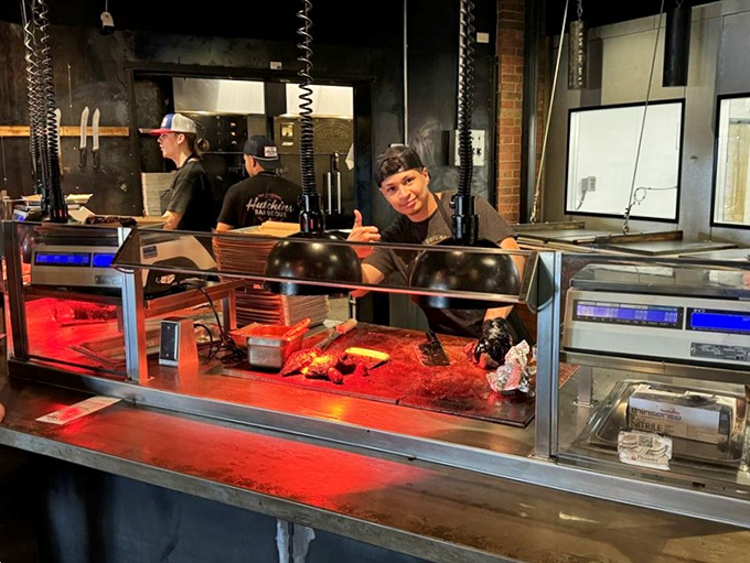 Behind the counter, where the magic happens. These folks are the unsung heroes of your soon-to-be food coma.
