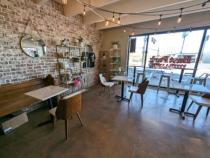 Cozy meets chic in this inviting dining area. With its exposed brick and twinkling lights, it's like your coolest friend's living room &ndash; if your friend was obsessed with donuts.