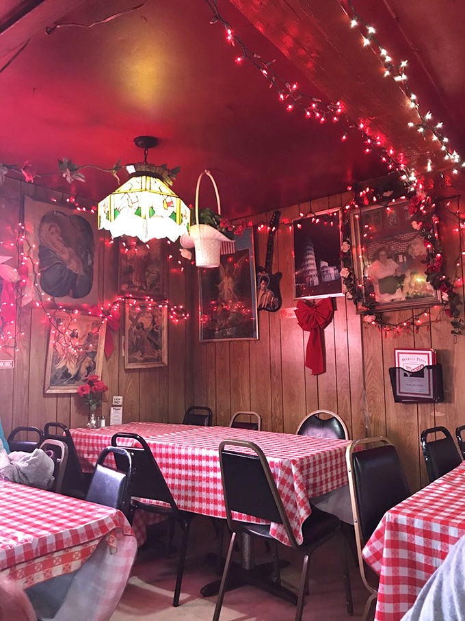 Welcome to pizza paradise! This dining area, with its festive lights and cozy ambiance, feels like your Italian grandma's living room (if she had amazing pizza skills).