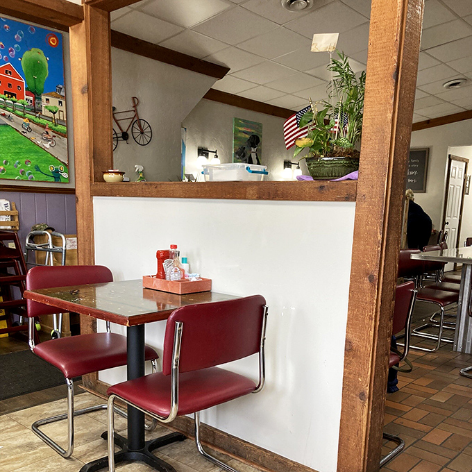 Red chairs, wood paneling, and charm galore. It's not just a dining area; it's a time machine to simpler days.