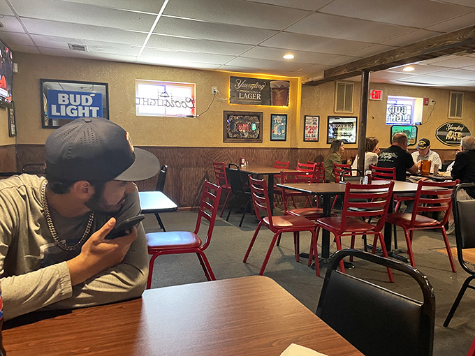 Red chairs pop against wooden tables in this no-nonsense dining area. It's not trying to impress you with decor&mdash;the food handles that job.