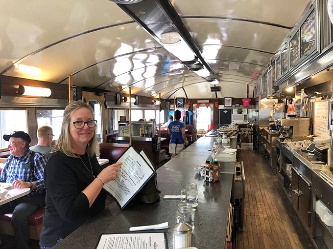 The diner's narrow aisle is like a runway where breakfast dreams take flight. Every seat offers a front-row view to culinary magic.