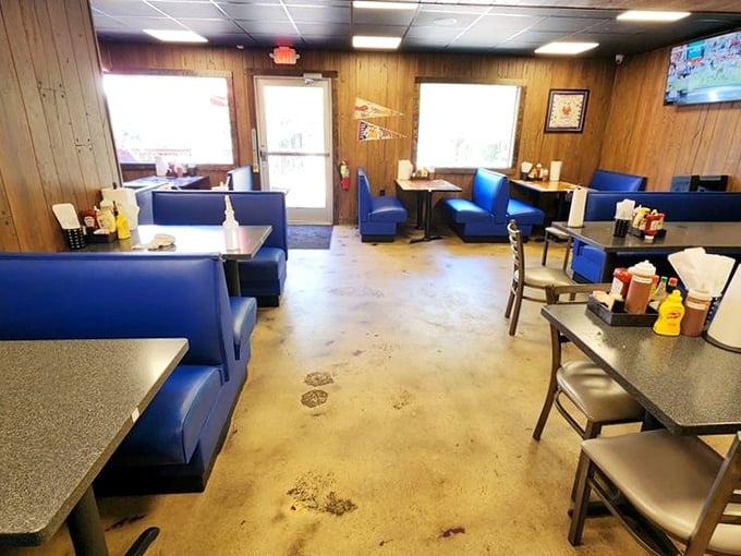 Blue booths and wood paneling: a time capsule of flavor where every seat promises a delicious adventure.