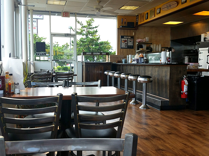 Simple tables, wood floors, and counter seating where barbecue magic happens. No white tablecloths needed when the food does all the talking.