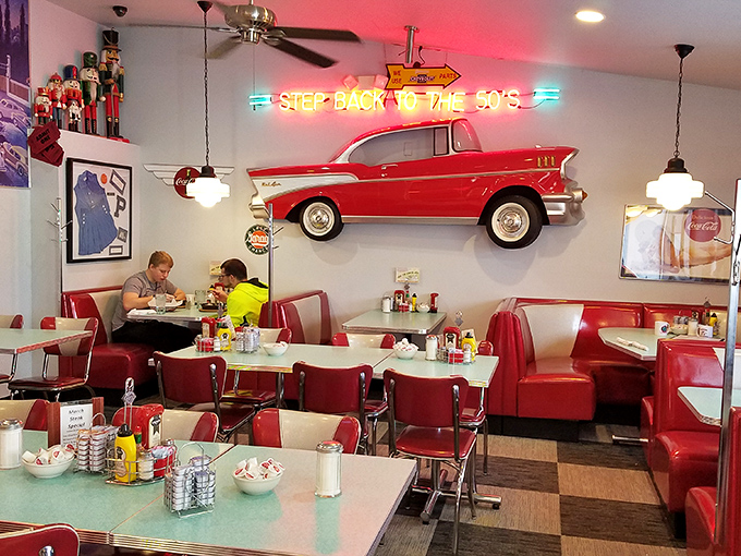 "Step Back to the 50's" indeed! This dining area is a time machine fueled by neon, nostalgia, and the occasional Elvis tune.