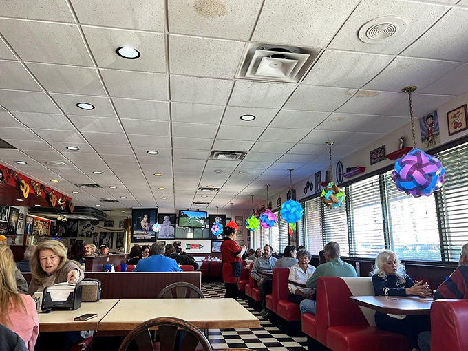 Red booths, checkered floors, and enough nostalgia to fill a jukebox. This dining area isn't just a room, it's a time machine with table service.