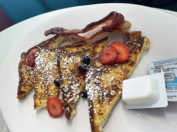 French toast that's dressed to impress! With a dusting of powdered sugar and fresh berries, it's like breakfast went to prom.