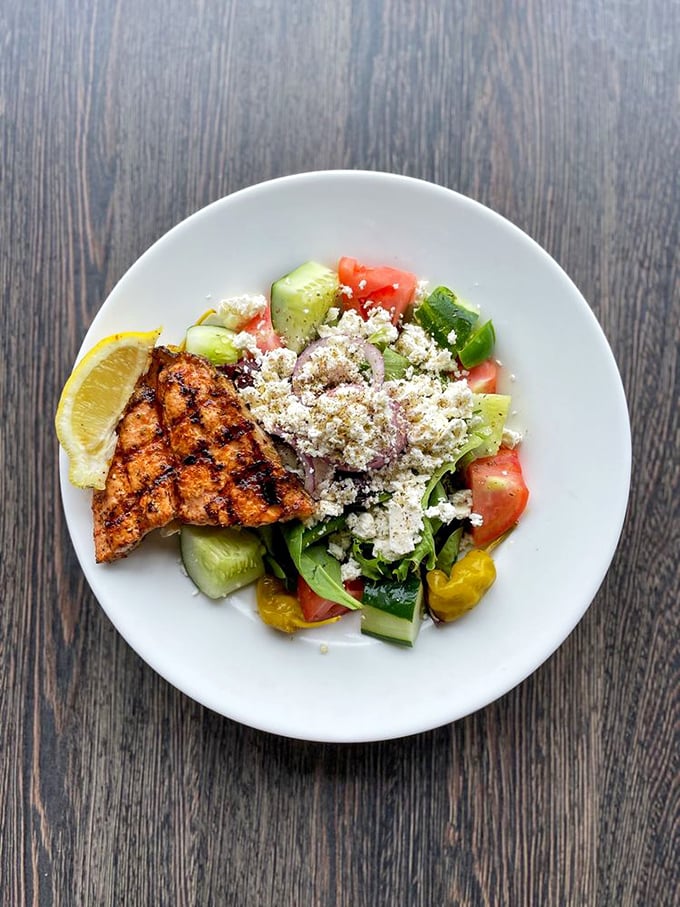 A Greek salad that's gone fishing and caught some perfectly grilled salmon. It's a Mediterranean vacation for your taste buds, no passport required.